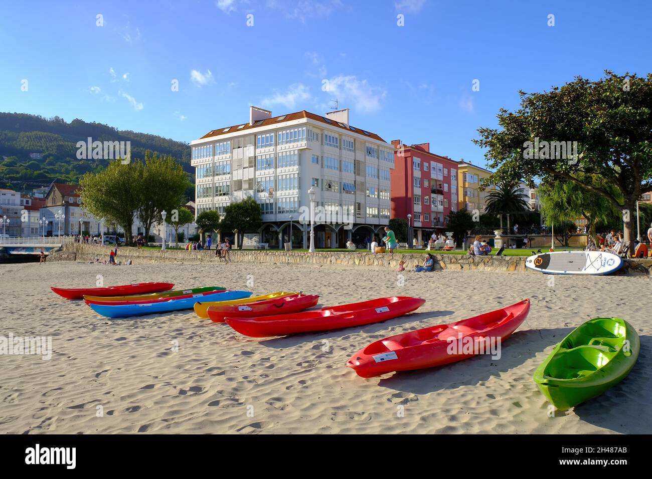 CEDEIRA, SPAIN - Jul 15, 2021: A row of kayaks on a sandy beach in ...
