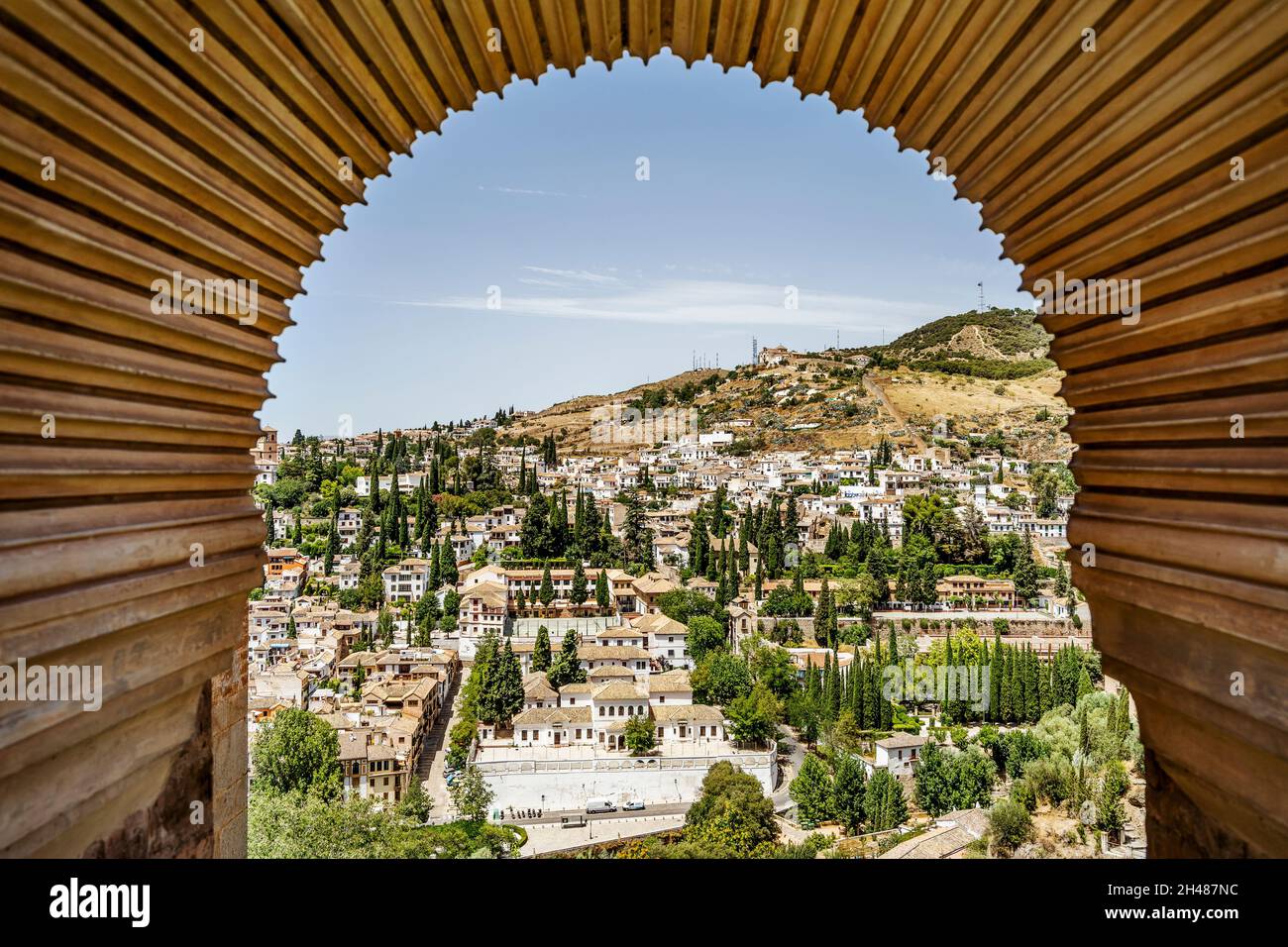 Granada cityscape viewed through the arch of Arabic palace complex ...
