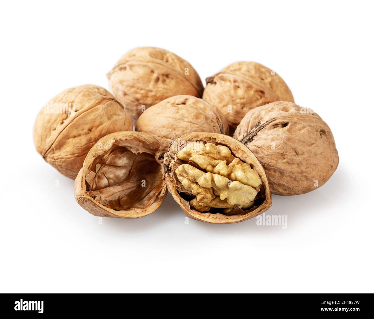 Whole and cracked walnuts on a white background. Half of walnut and ...
