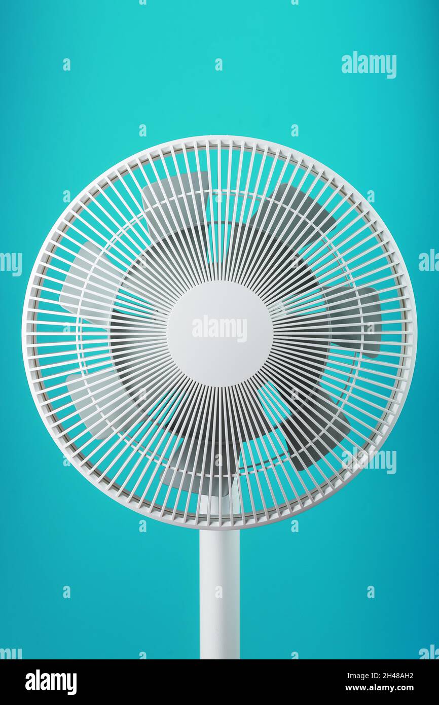 A high-tech white electric fan with a modern design for cooling the ...