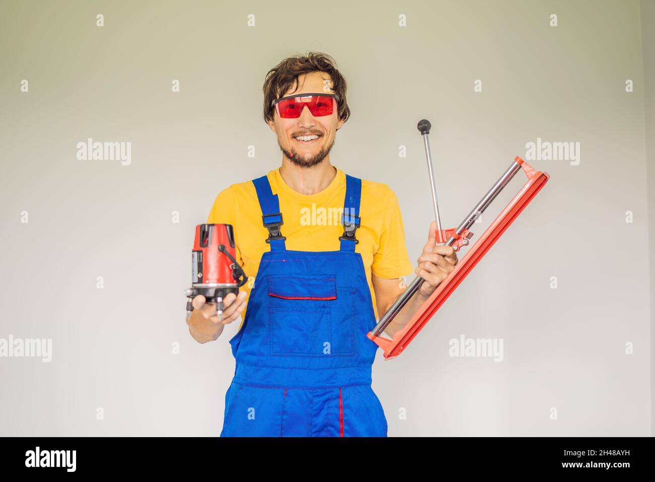 Hand holds tile cutter tool hi-res stock photography and images - Alamy