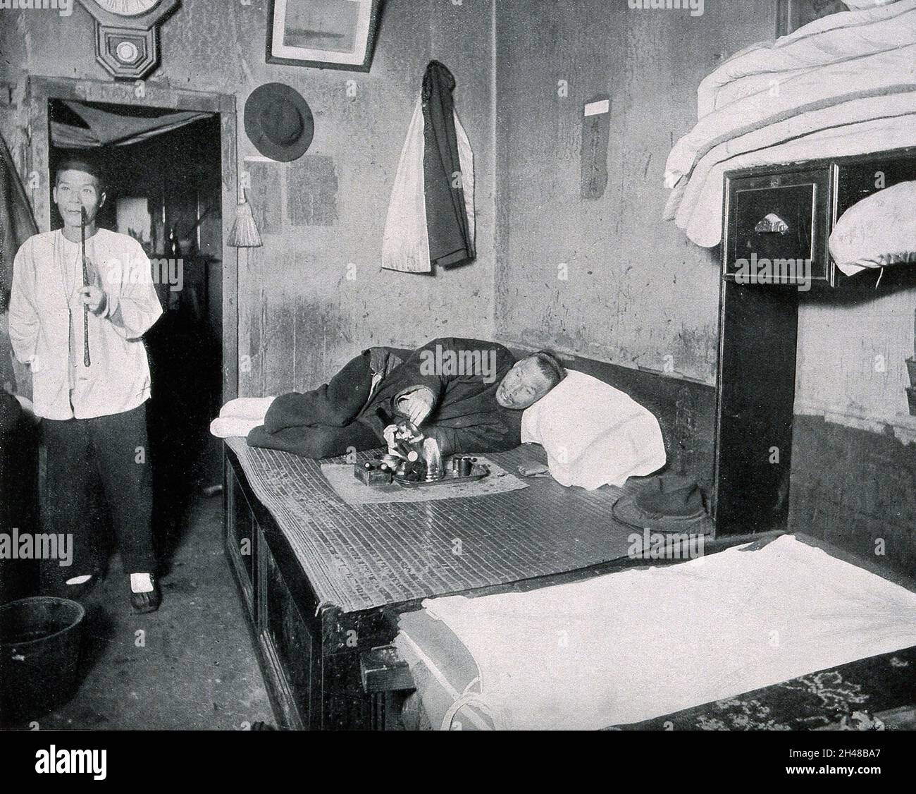 An opium den in San Francisco, early 20th century, with two Chinese men ...