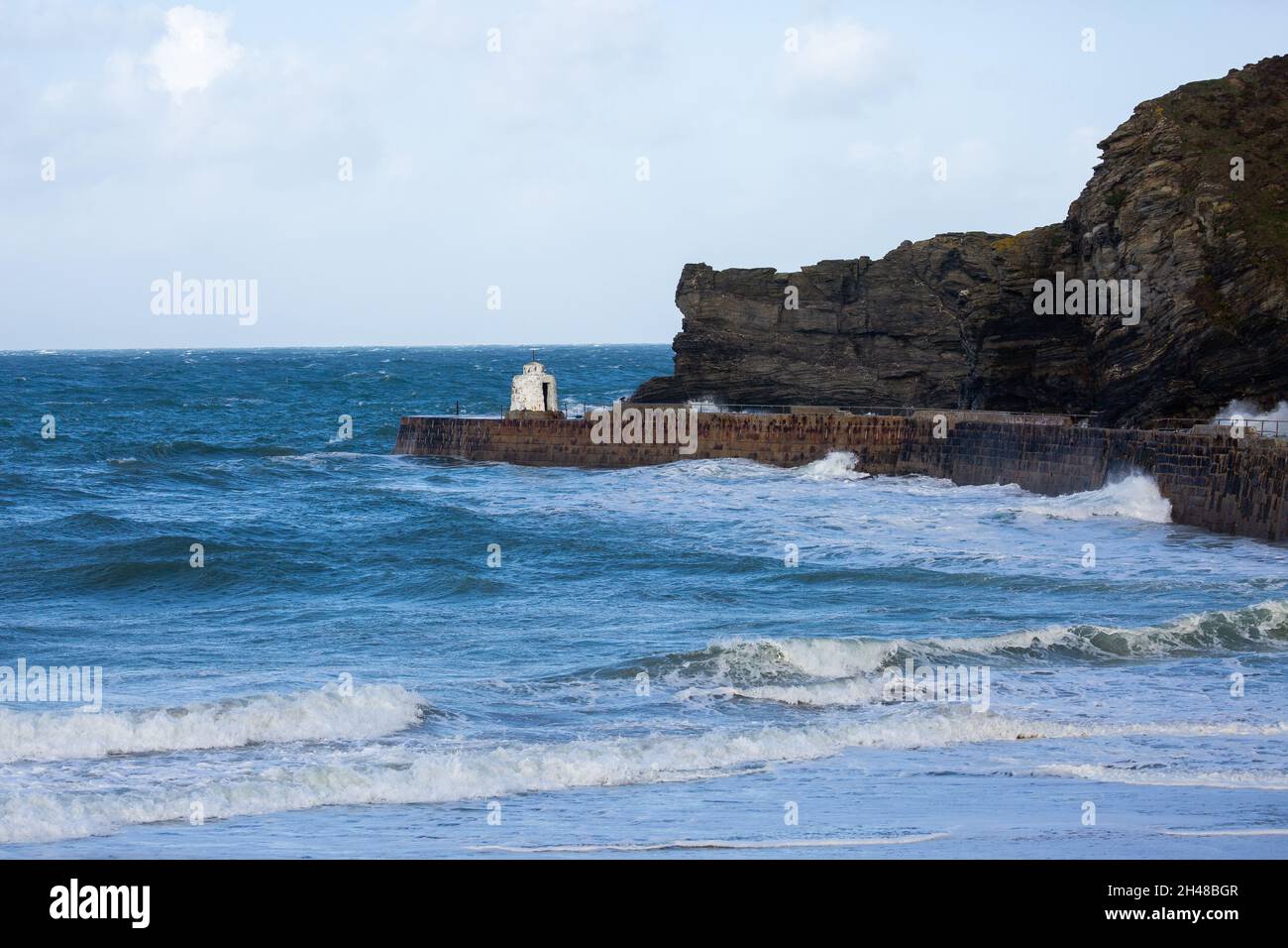 Large waves crash across the Monkey Hut at high tide in Portreath ...