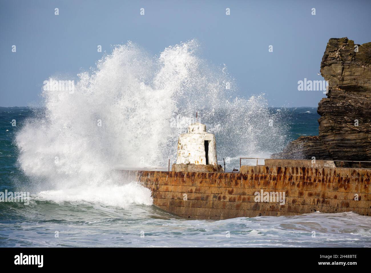 Large waves crash across the Monkey Hut at high tide in Portreath ...
