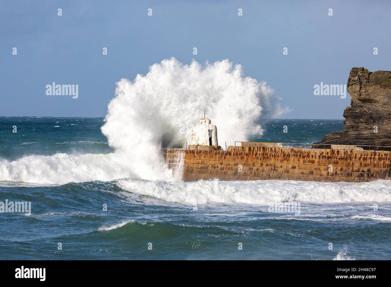 Large waves crash across the Monkey Hut at high tide in Portreath ...