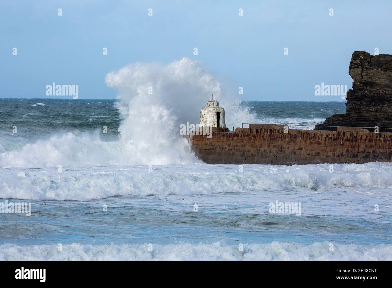 Large waves crash across the Monkey Hut at high tide in Portreath ...