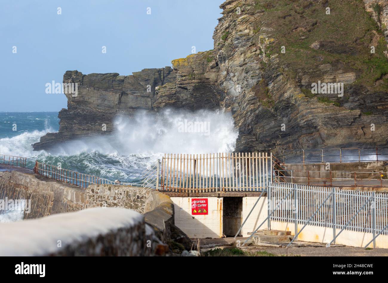Large waves crash across the Monkey Hut at high tide in Portreath ...