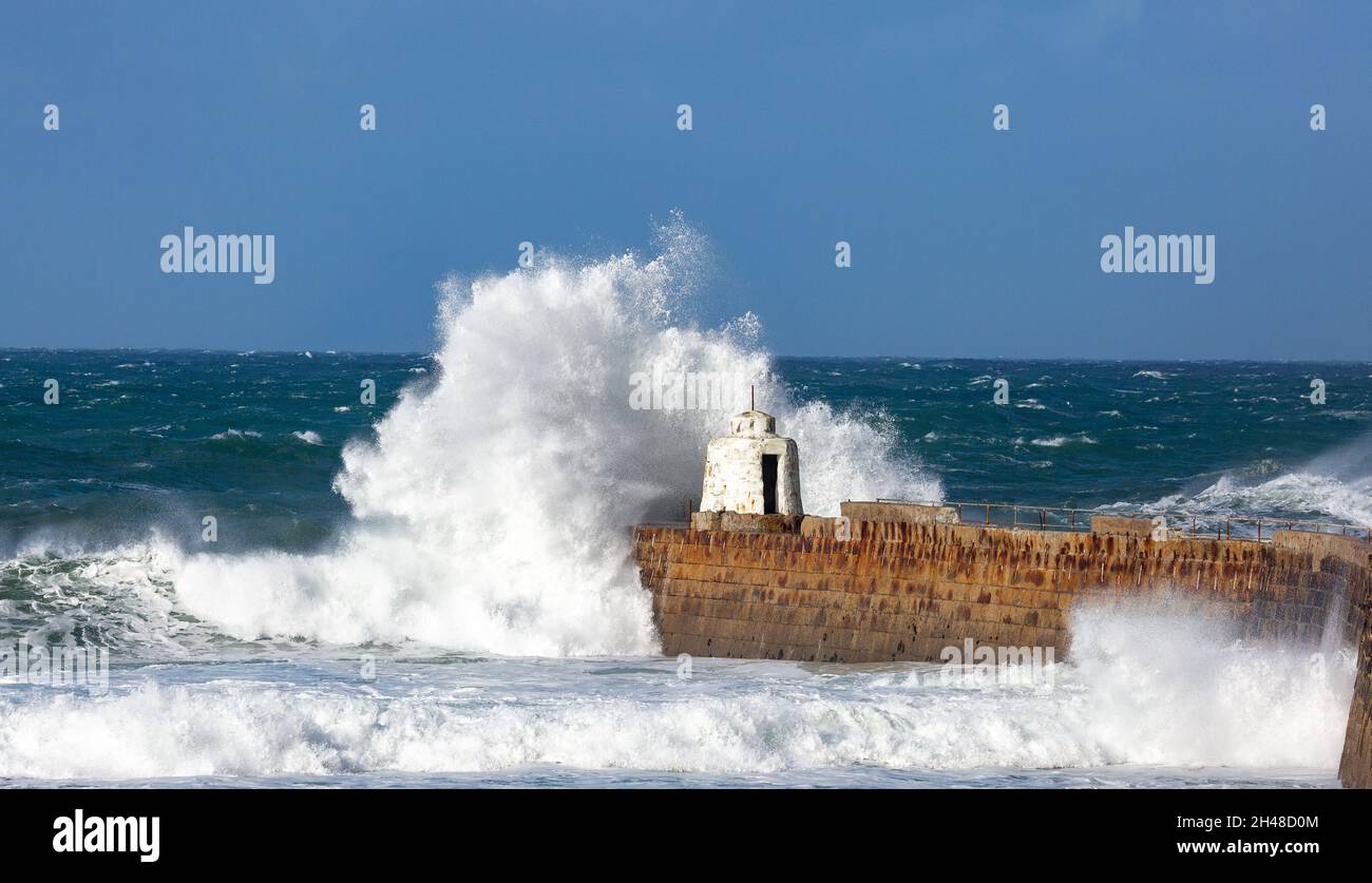 Large waves crash across the Monkey Hut at high tide in Portreath ...