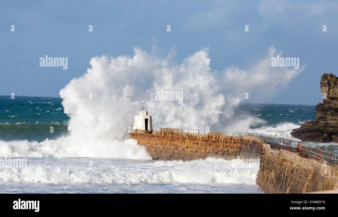 Large waves crash across the Monkey Hut at high tide in Portreath ...