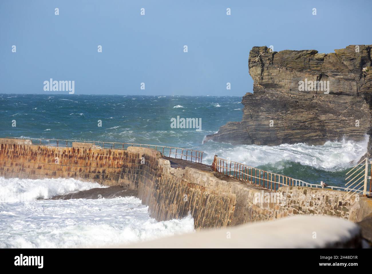 Large waves crash across the Monkey Hut at high tide in Portreath ...