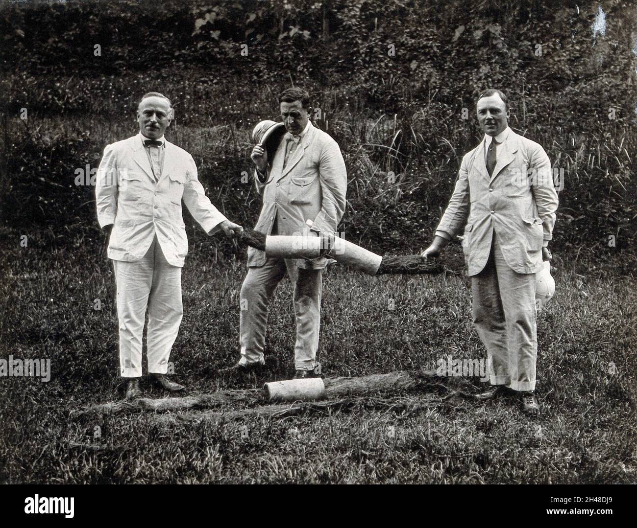 Kuala Lumpur, Malaysia: three men in pale-coloured suits holding up ...