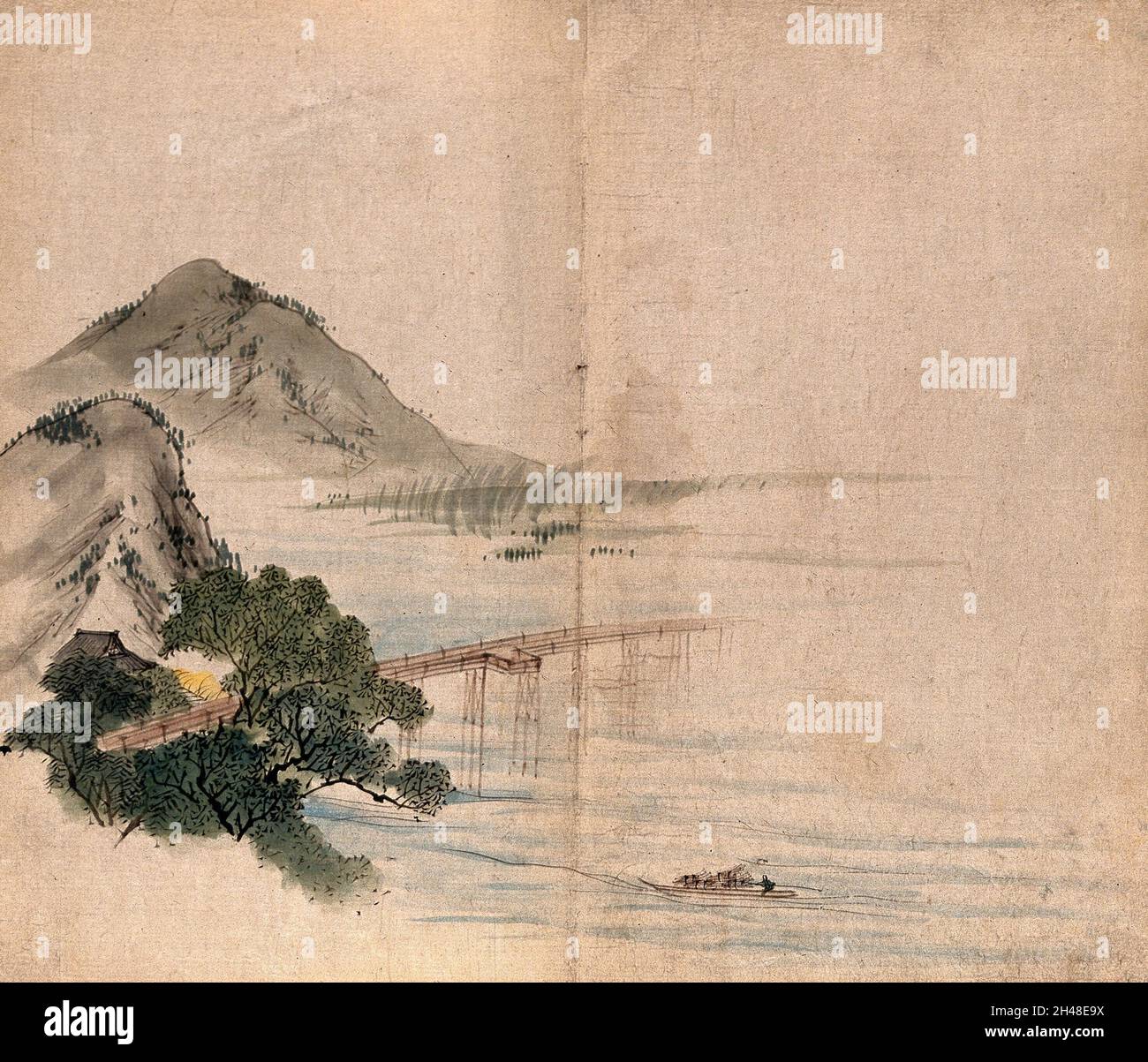 Two hills and some trees by a lake over which stretches a high bridge ...