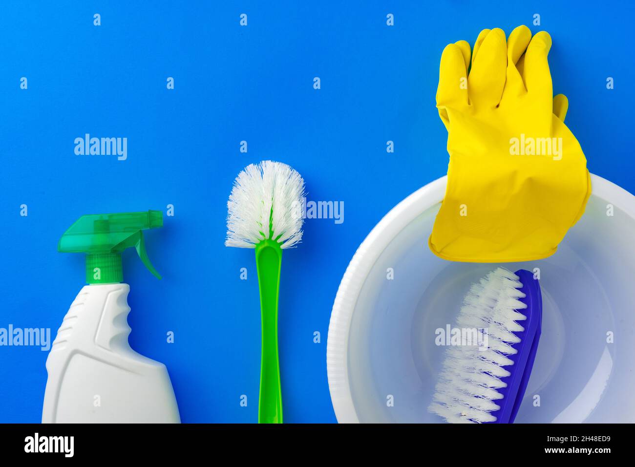House cleaning supplies on blue color background Stock Photo - Alamy