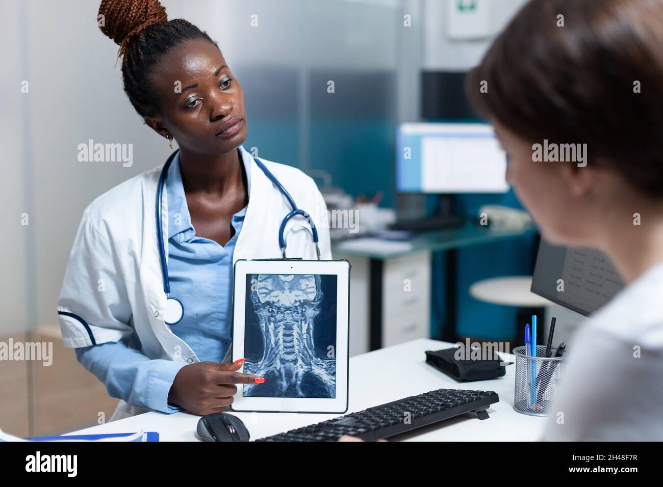 African american radiologist doctor holding tablet computer showing ...