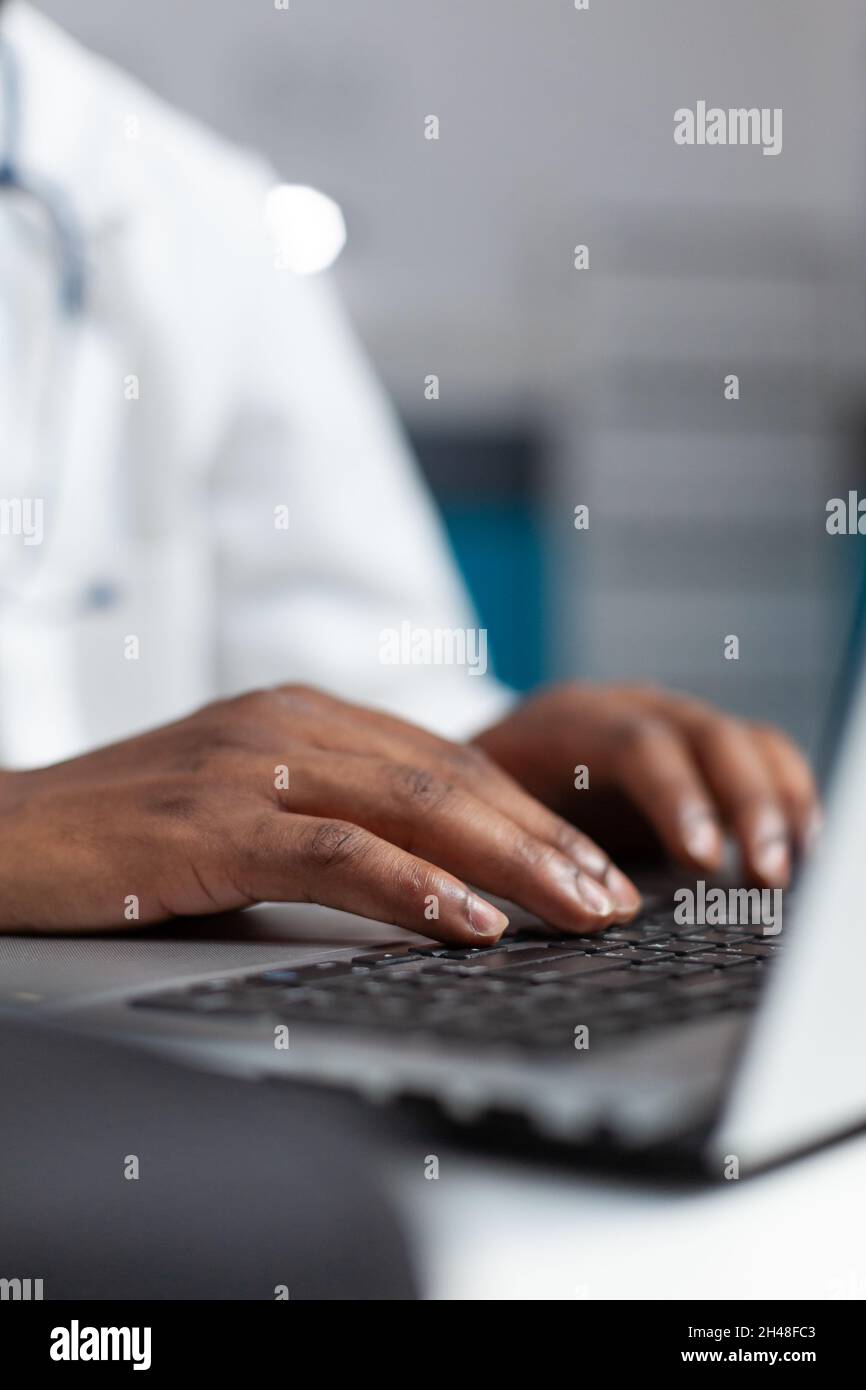 Closeup of african american therapist hand typing medical prescription ...