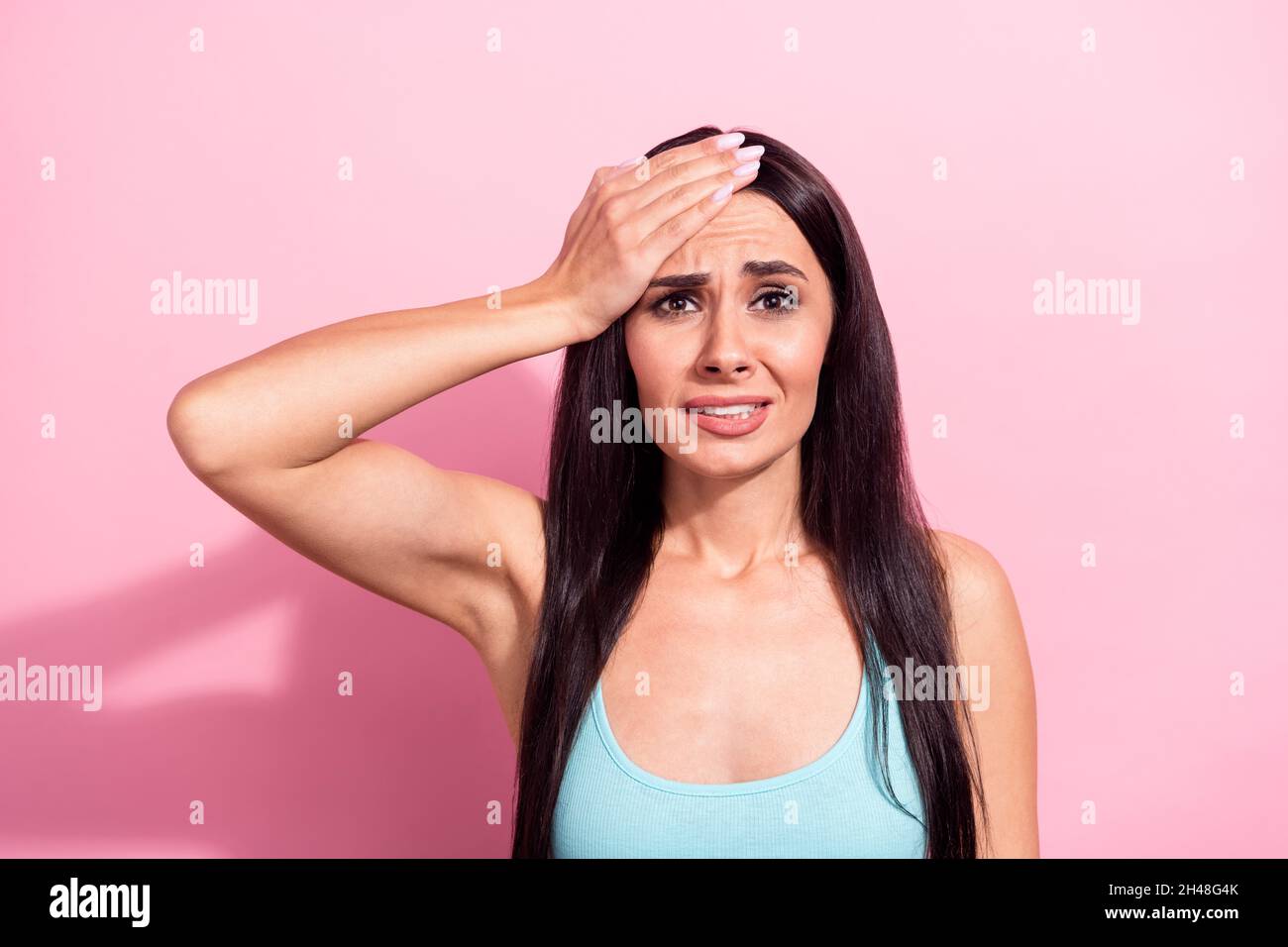 Photo portrait of young woman keeping hands on forehead did mistake ...