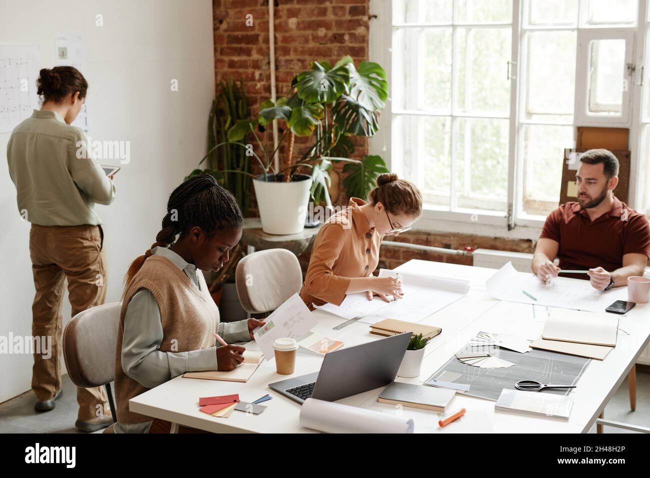 Diverse group of creative architects working in modern office Stock ...