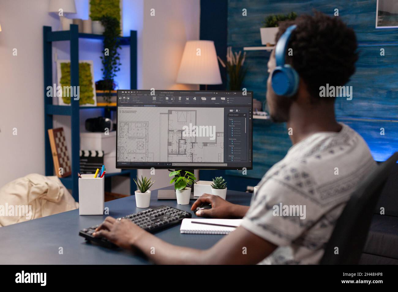 African american young architect with headphone developing construction ...