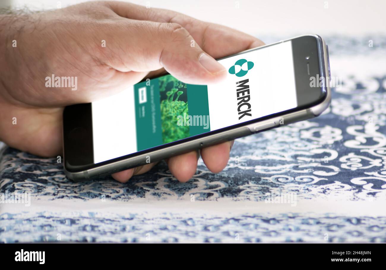 New York, USA, October 2021: A hand holding a phone with the Merck ...