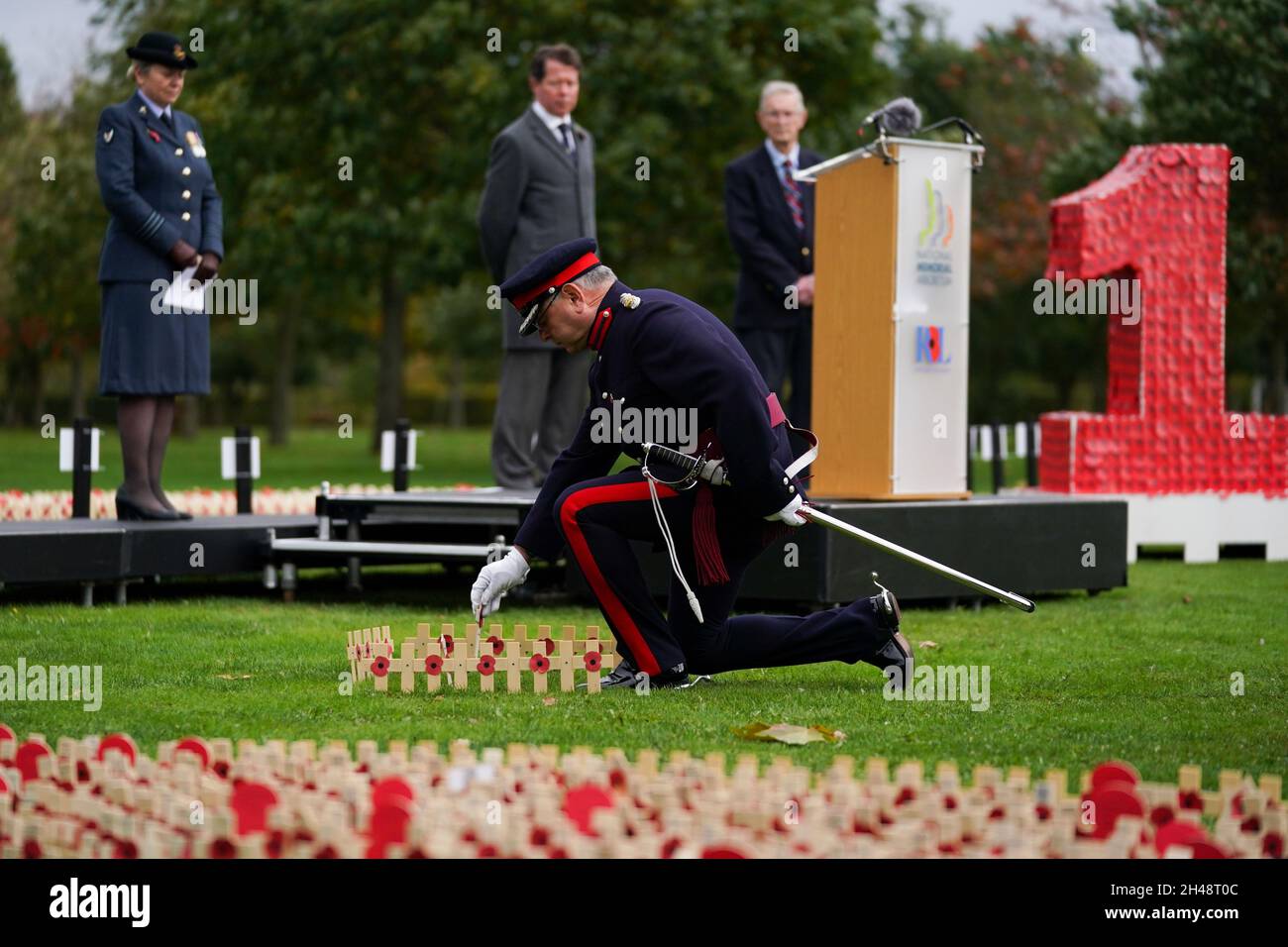 Members of the military plant their own tributes during the official ...