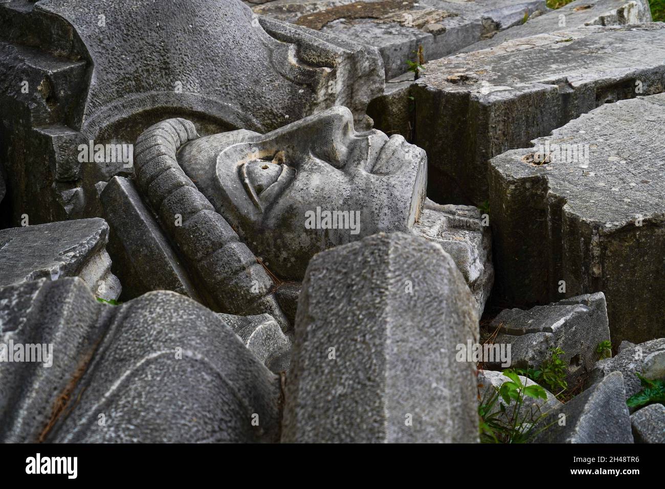 Remains of an ancient broken Greek style stone statue the Head with ...