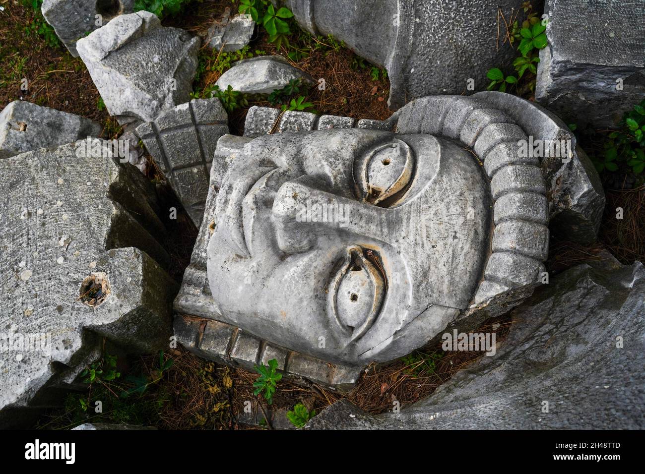 Remains of an ancient broken Greek style stone statue the Head with ...