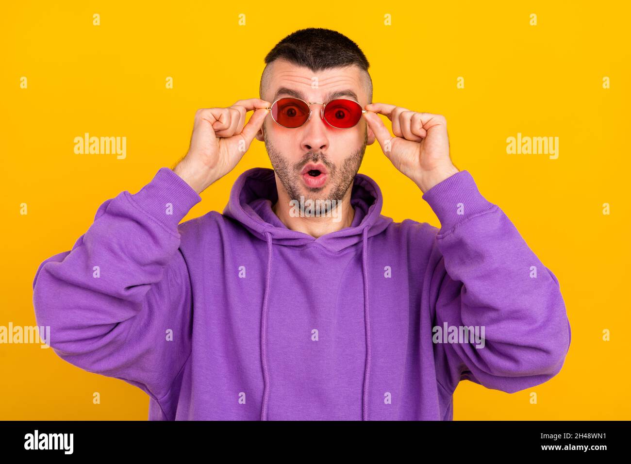 Photo of funky young brunet guy wear eyewear purple hoodie isolated on ...