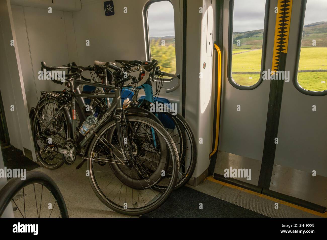 Road bikes stacked on the Settle Carlisle railway with people going in ...