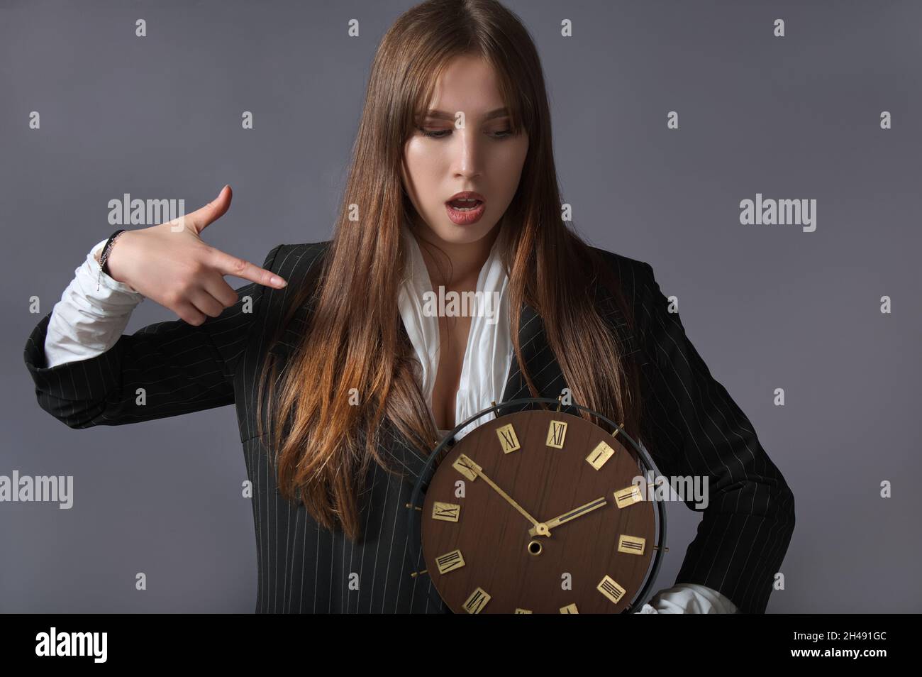 business girl shows a gesture with a finger at the clock Stock Photo ...