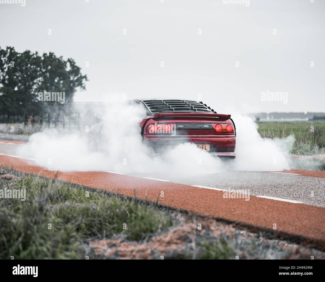 Back view of a red car Stock Photo - Alamy