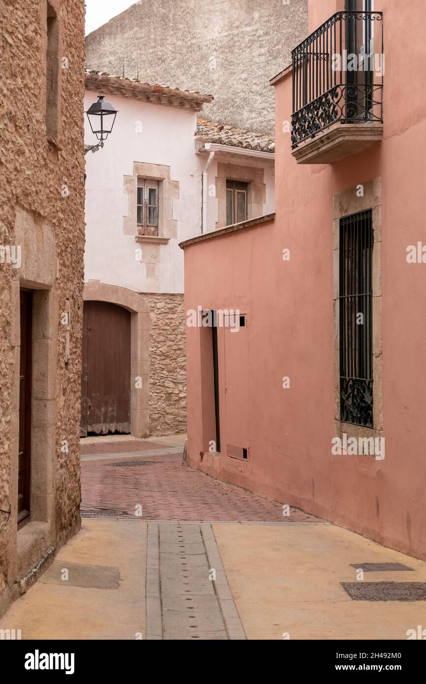 old street in begur with pastel colored houses Stock Photo - Alamy