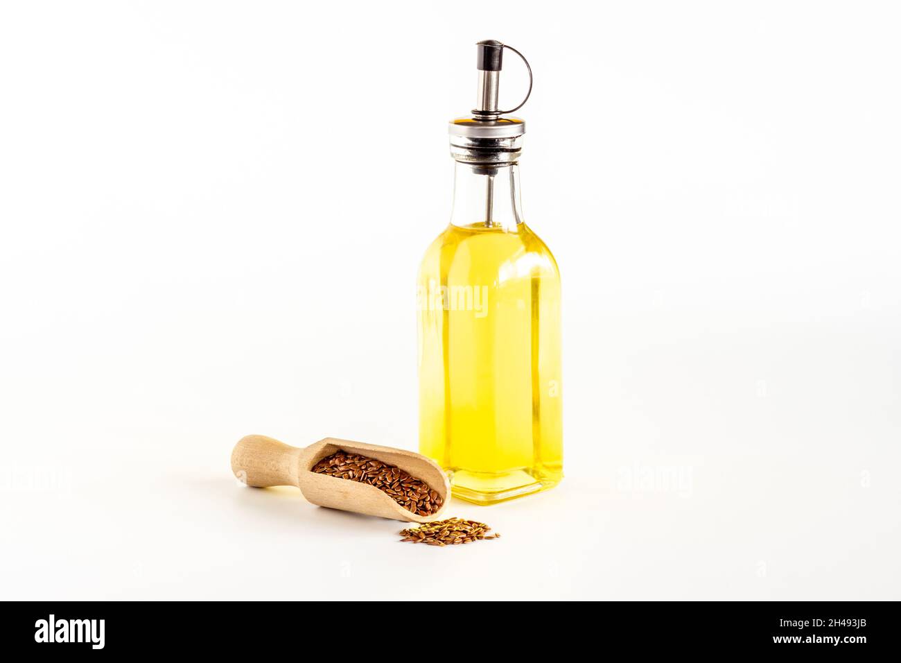 Sesame oil in glass bottle with sesame seeds. Extra virgin oil for food ...