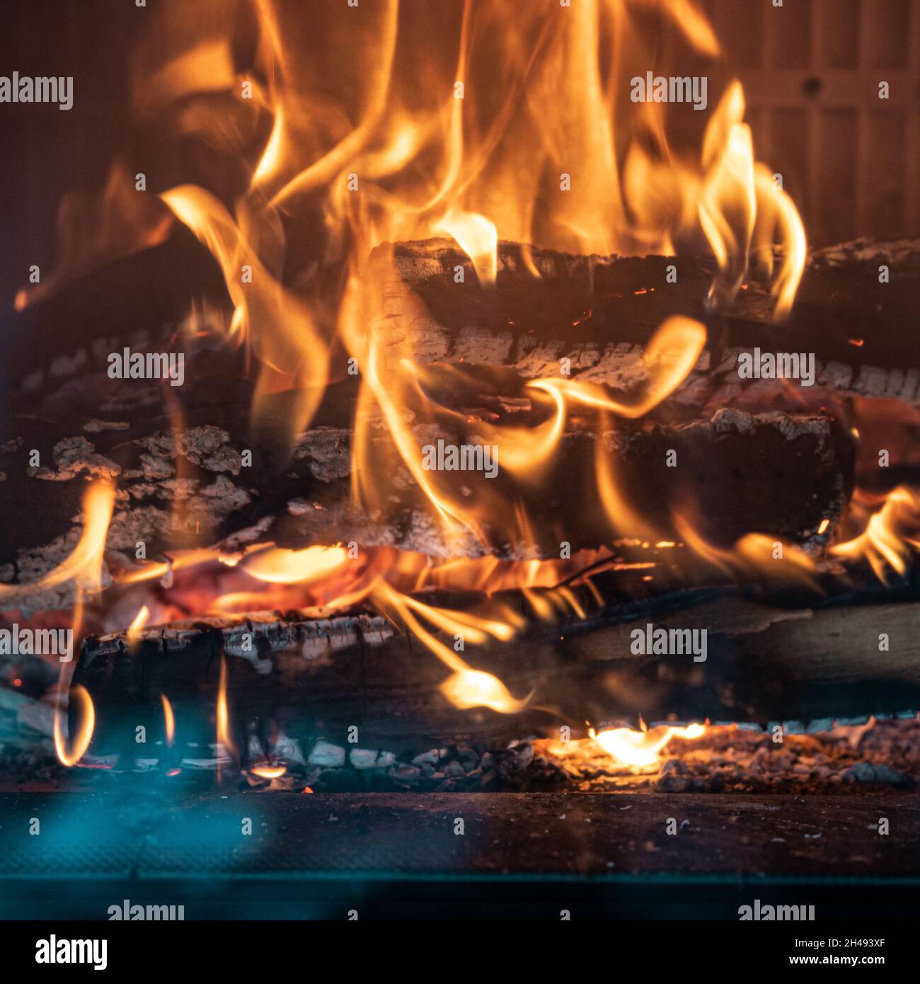 Flames from firewood in the fireplace, fire through the glass, burned ...