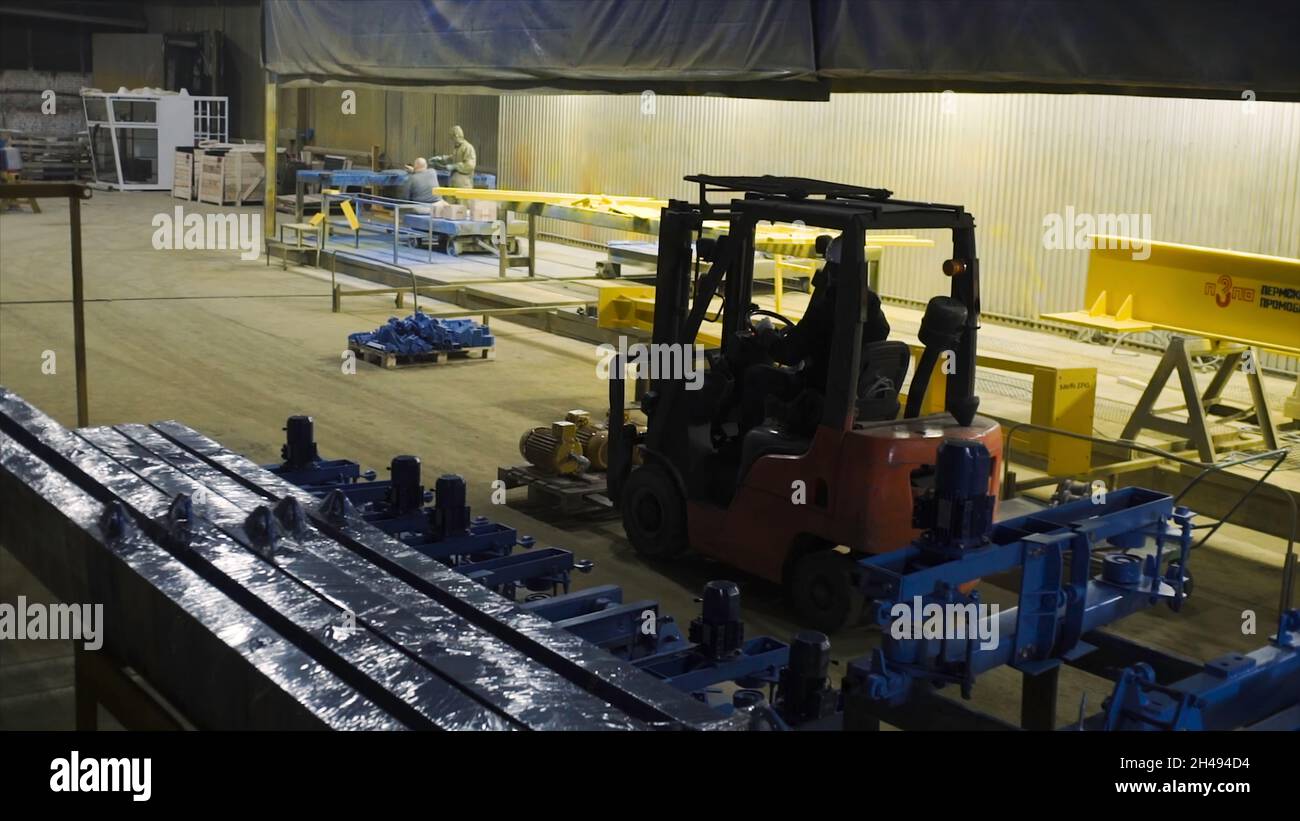 Loader carries parts in factory. Clip. Forklift truck carries heavy ...