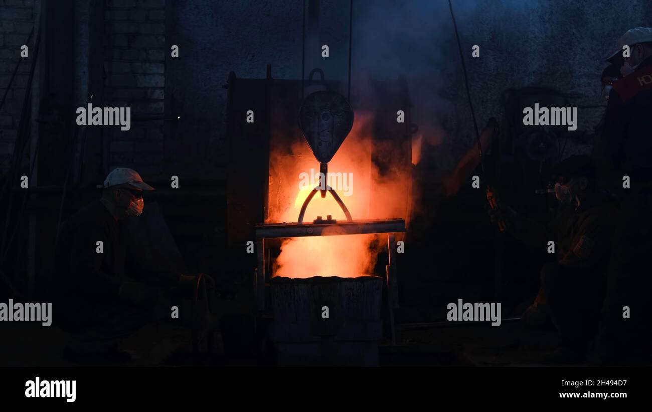 Workers poured molten metal at plant. Stock footage. Workers in form ...