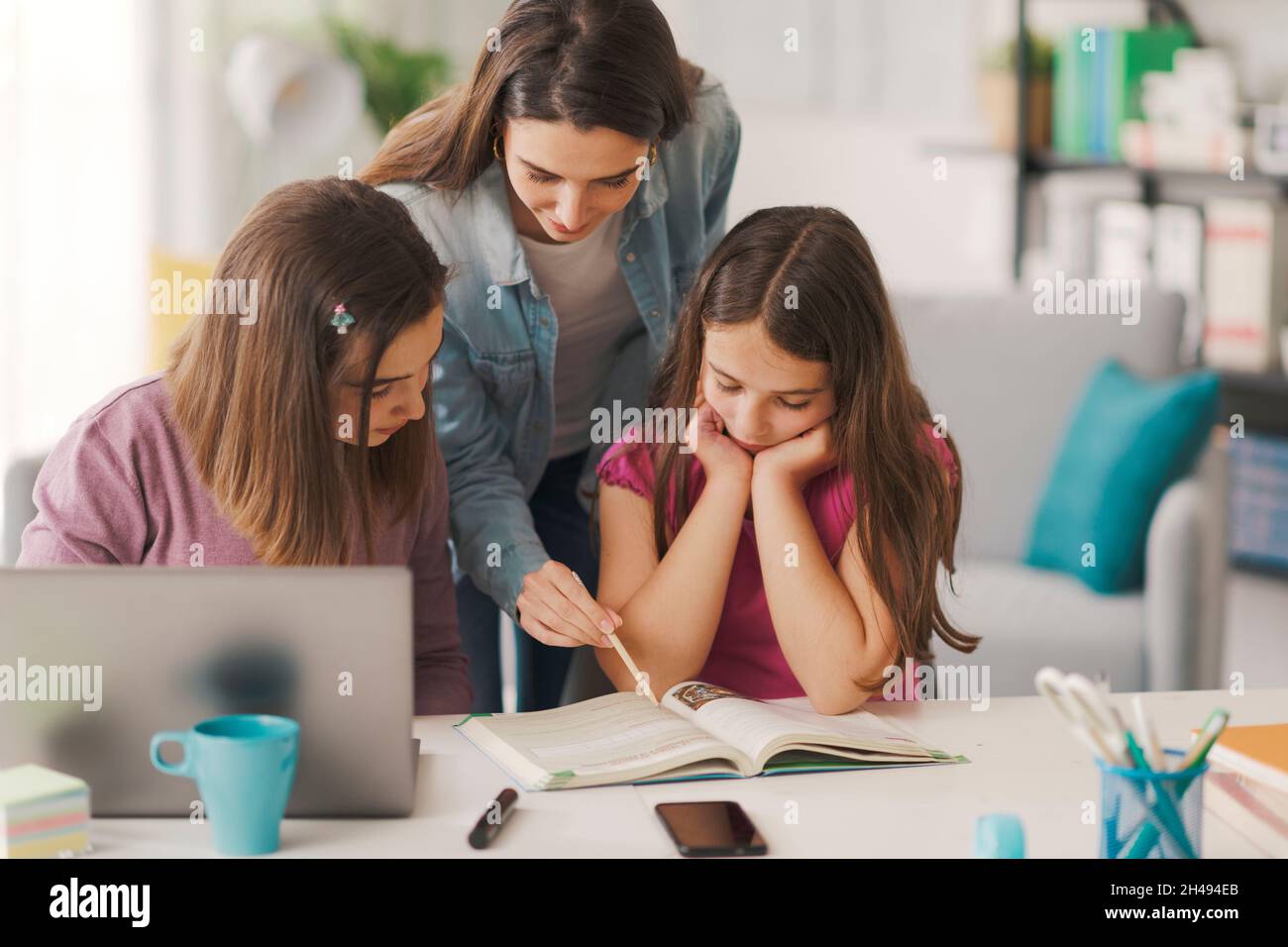 Happy students doing homework together, education and learning at home ...