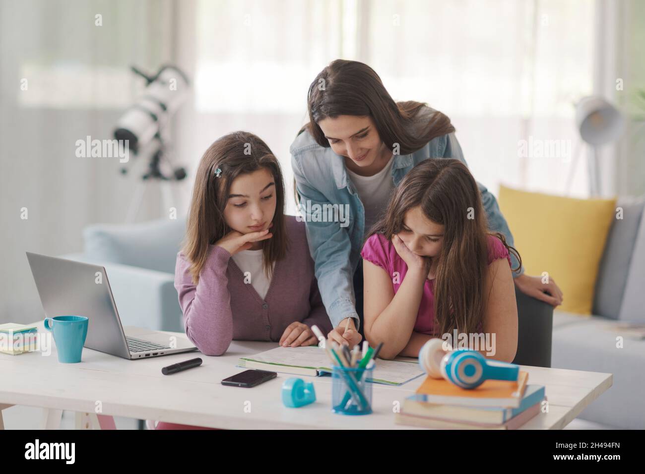 Happy students doing homework together, education and learning at home ...