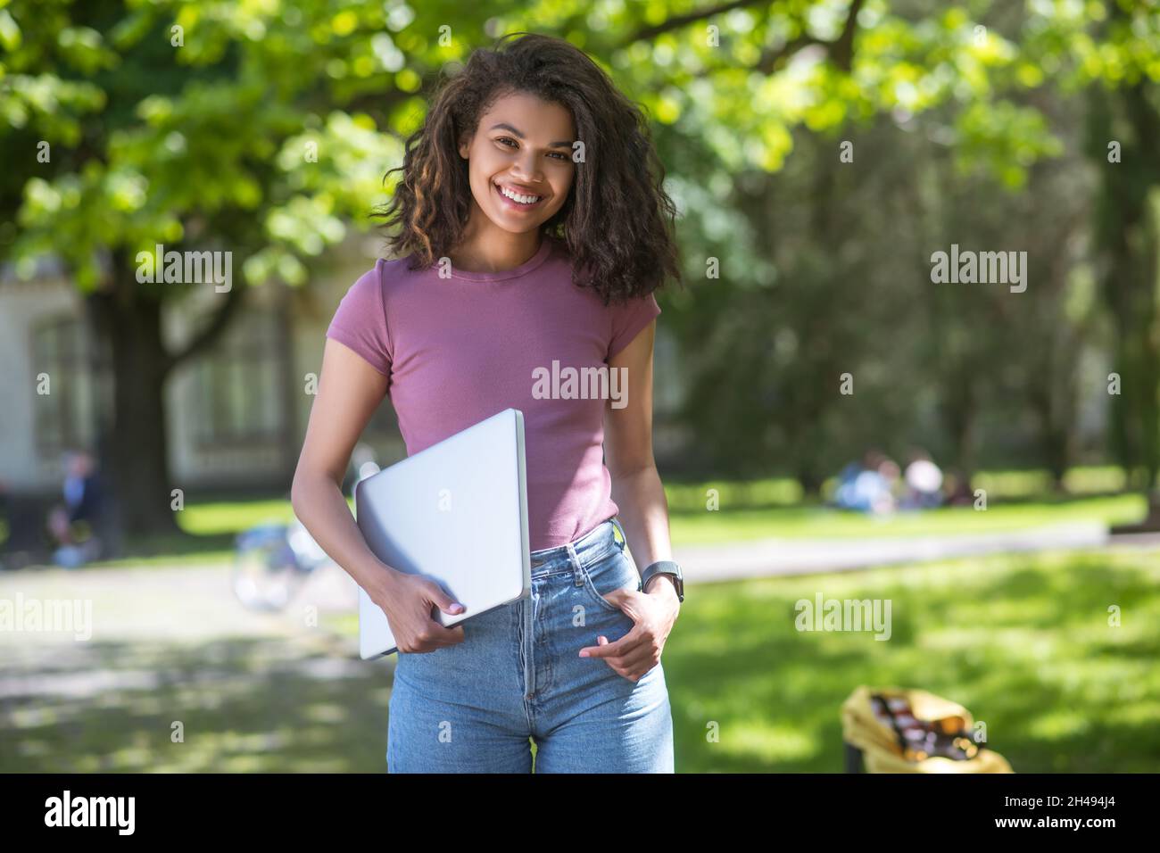 A pretty dark-skinned girl studying on the park Stock Photo - Alamy