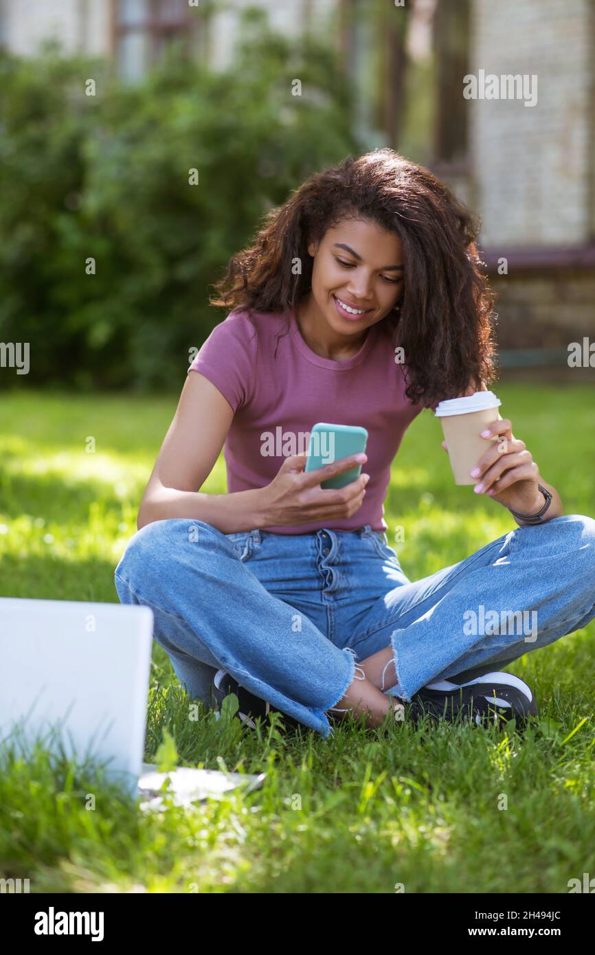 A pretty dark-skinned girl studying on the park Stock Photo - Alamy