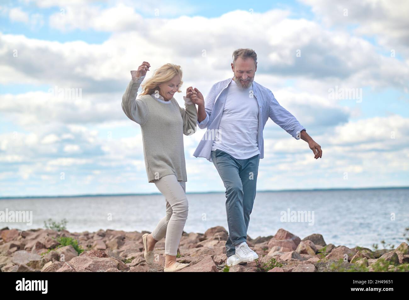 Woman walking on seashore hi-res stock photography and images - Alamy