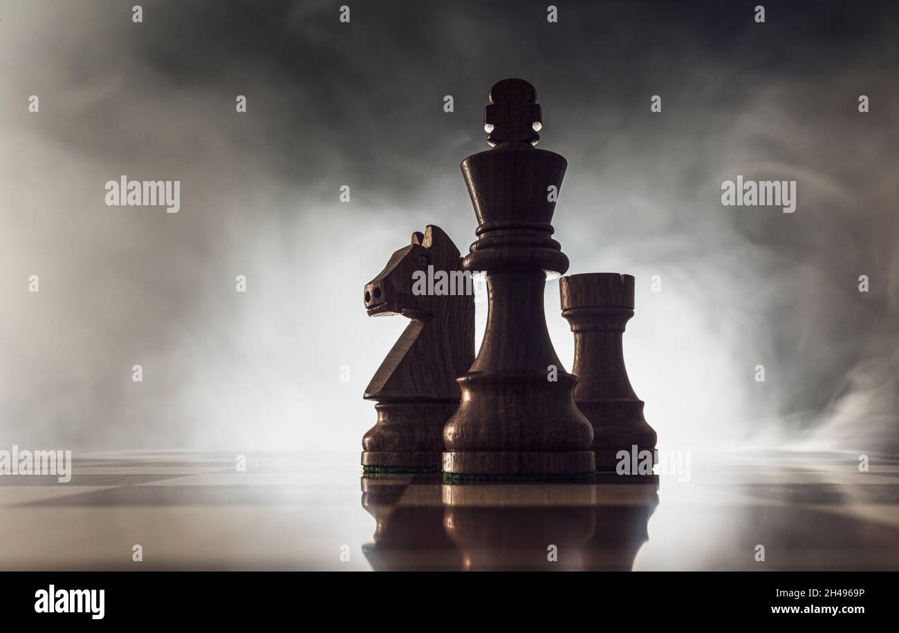 Wooden chess pieces and smoke: competition games and challenge concept ...