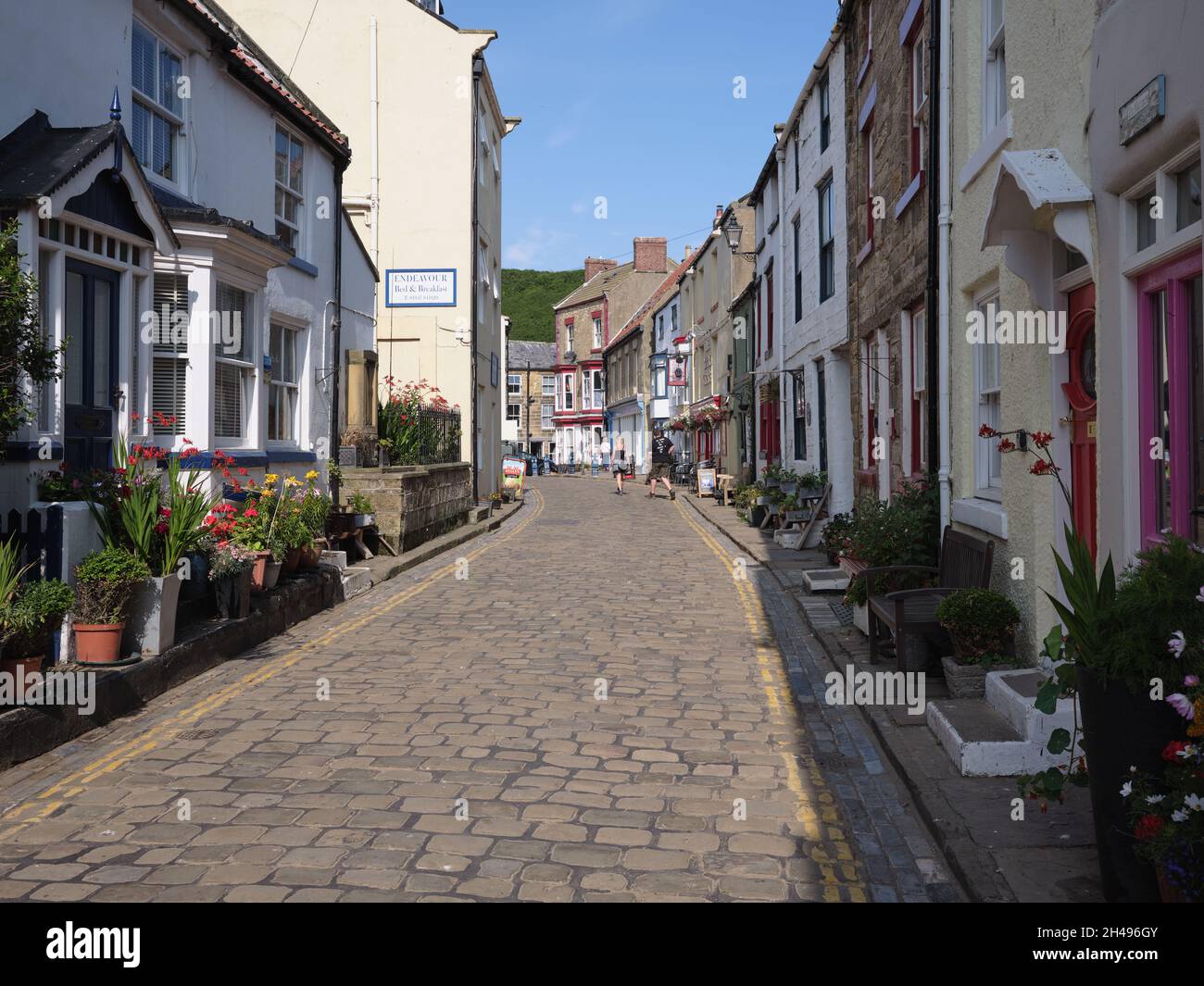 The main high street with shops and pubs in Staithes seaside village in ...