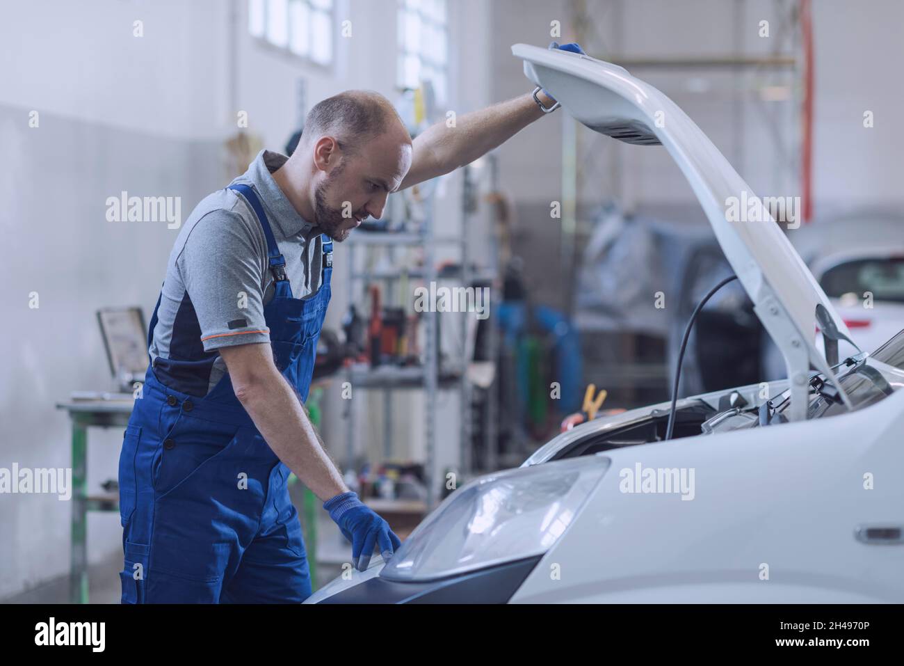 Professional mechanic at work, he is checking the car engine Stock ...