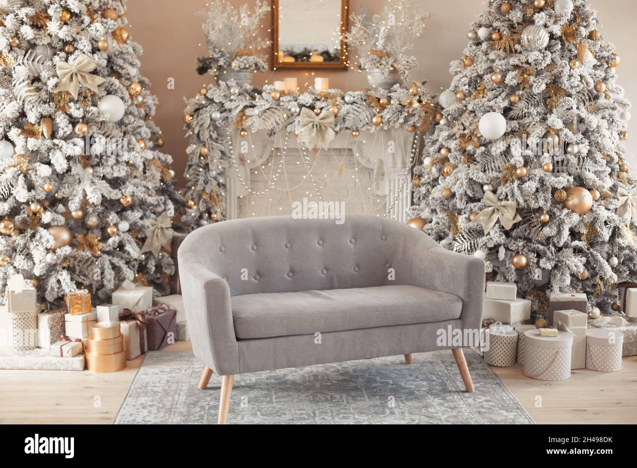 Hall room interior with a couch, fireplace with candles and decorated ...