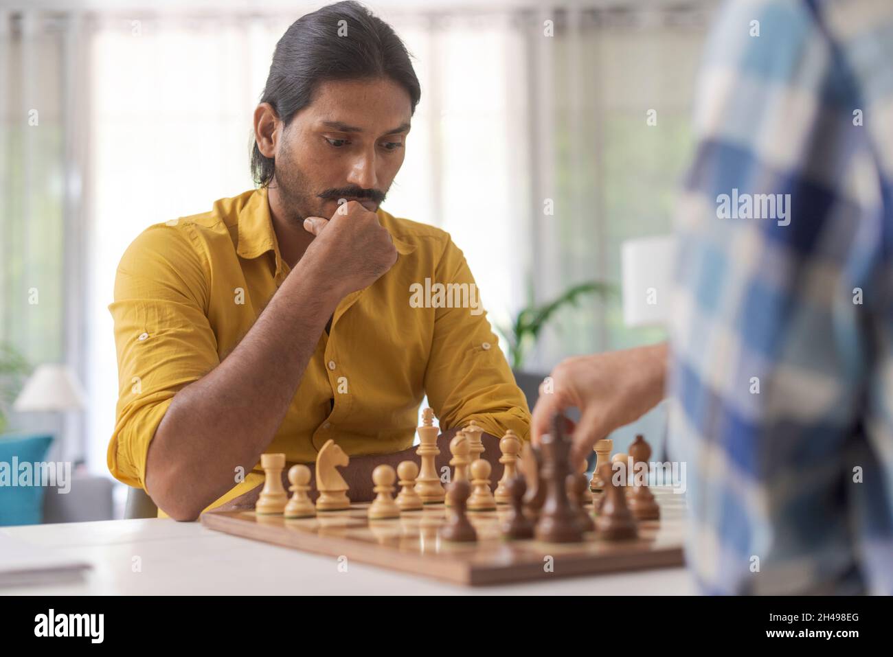 Two men playing chess at home, strategy games and competition concept ...