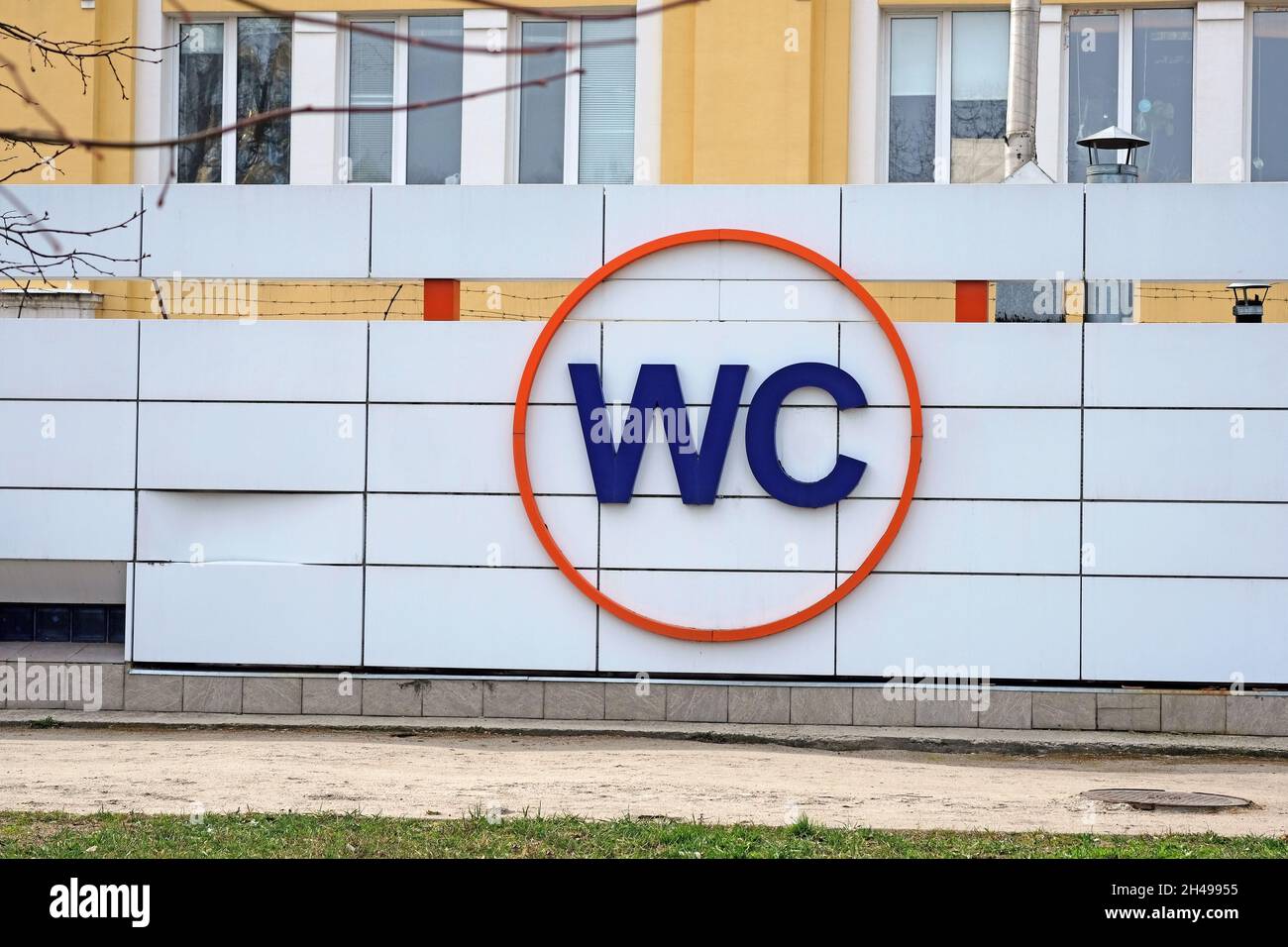 Large letters WC on facade of building. WC sign on the wall. Public ...