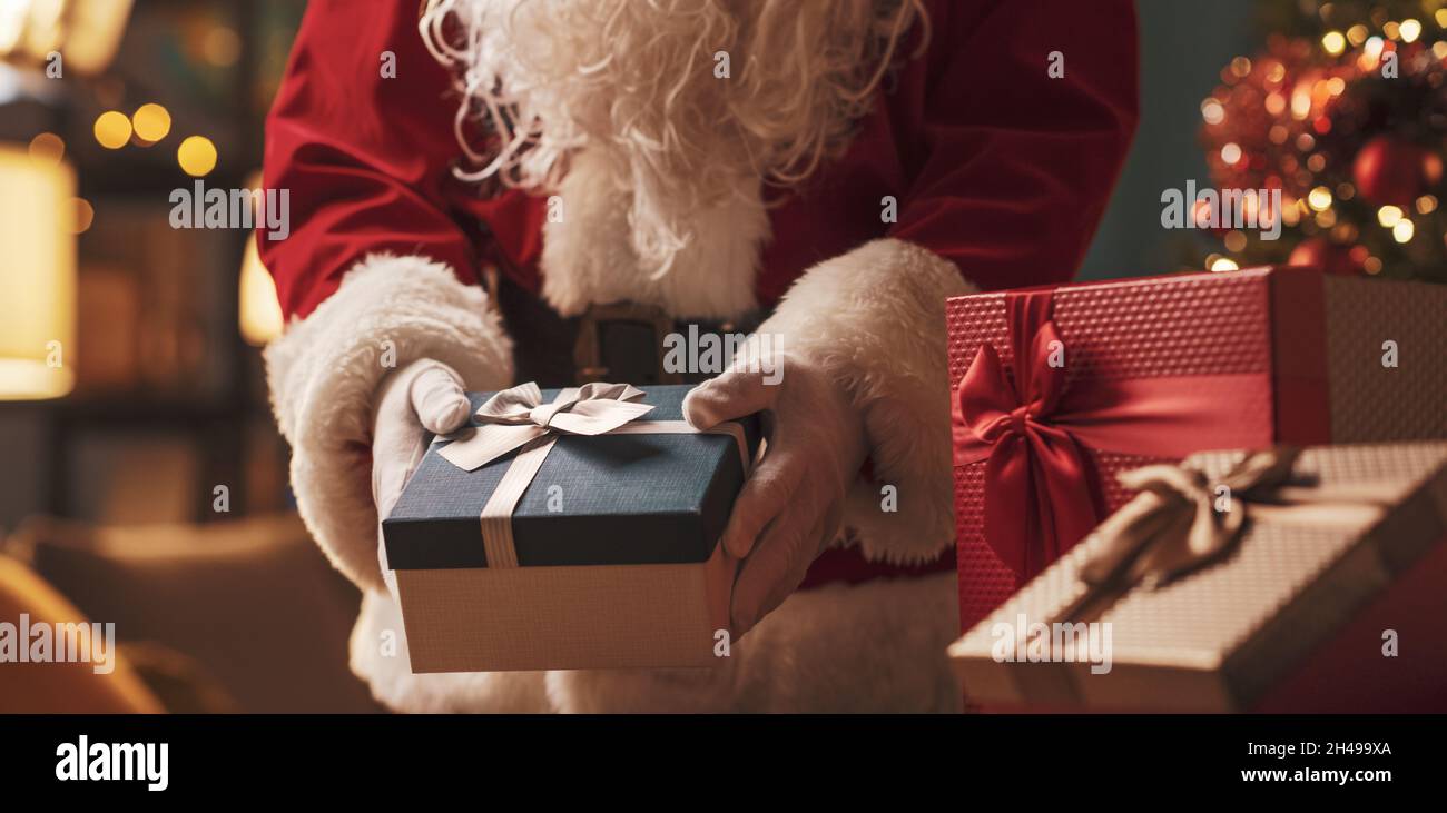 Santa Claus delivering Christmas gifts at home, holidays and ...