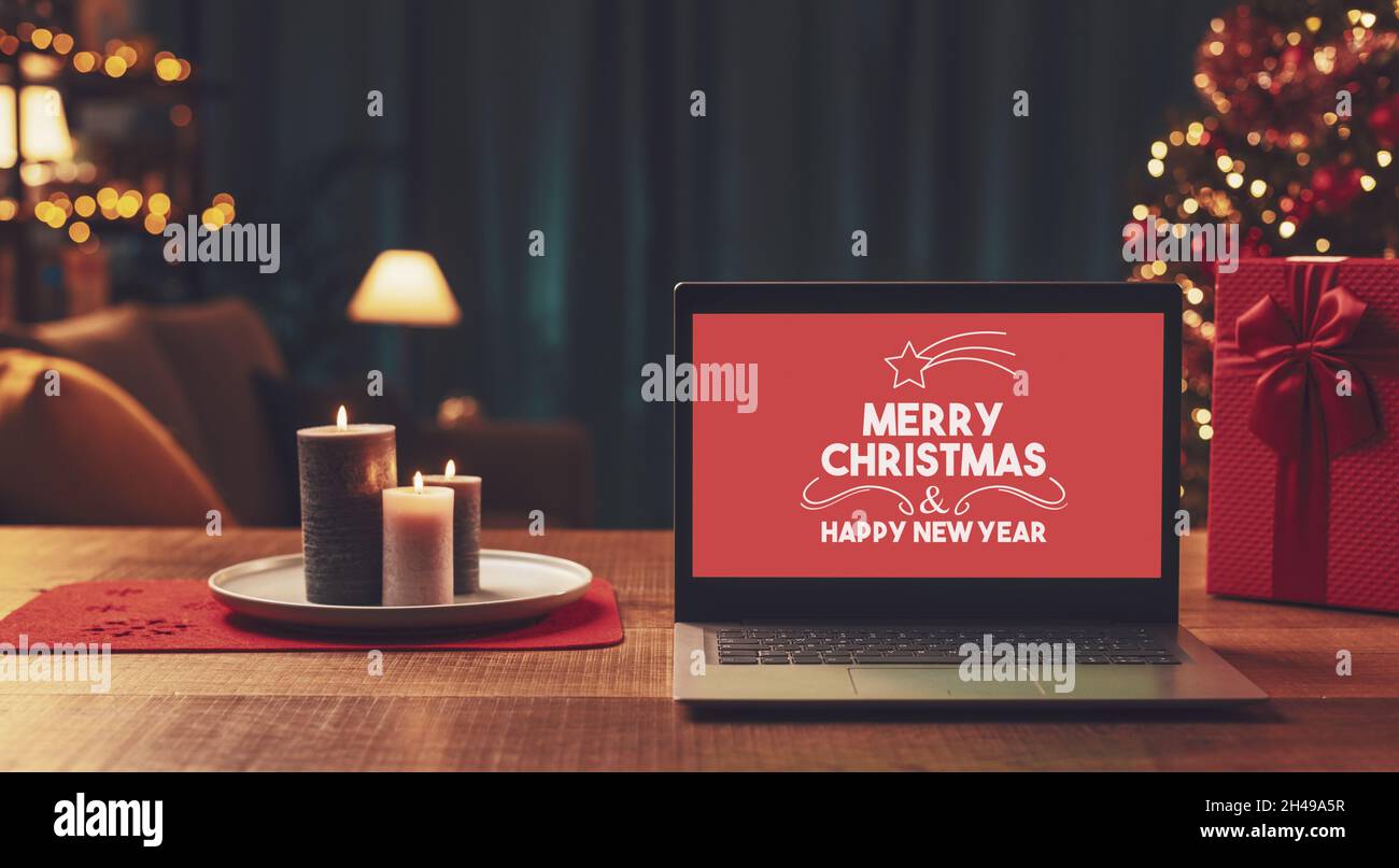 Merry Christmas and Happy New Year wishes on a laptop Stock Photo - Alamy