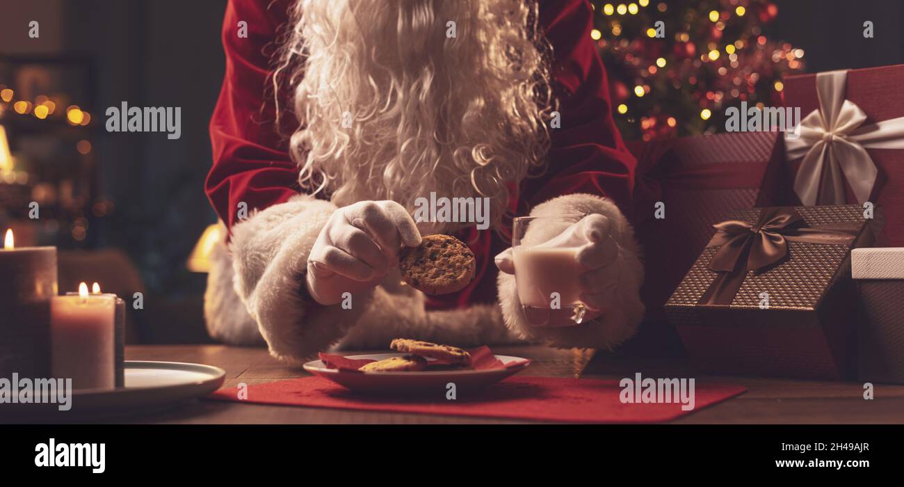 Santa claus eating cookies hi-res stock photography and images - Alamy