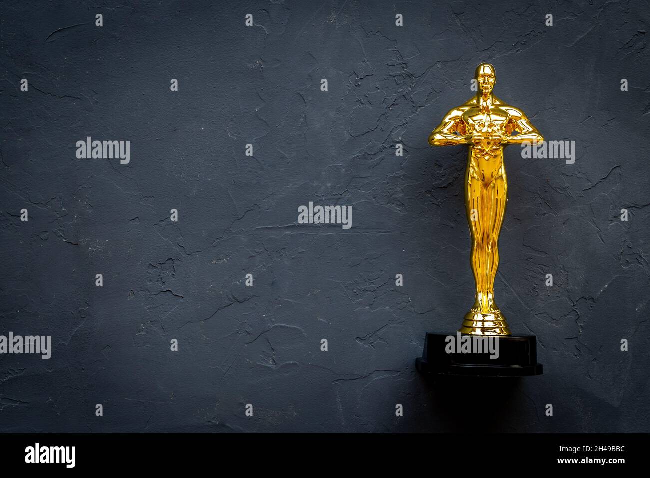 Golden film award statue - winner of movie industry Stock Photo - Alamy